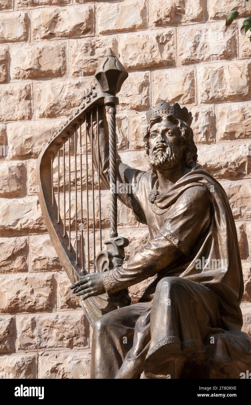 Bronze statue of King David playing the harp outside his tomb in the ...