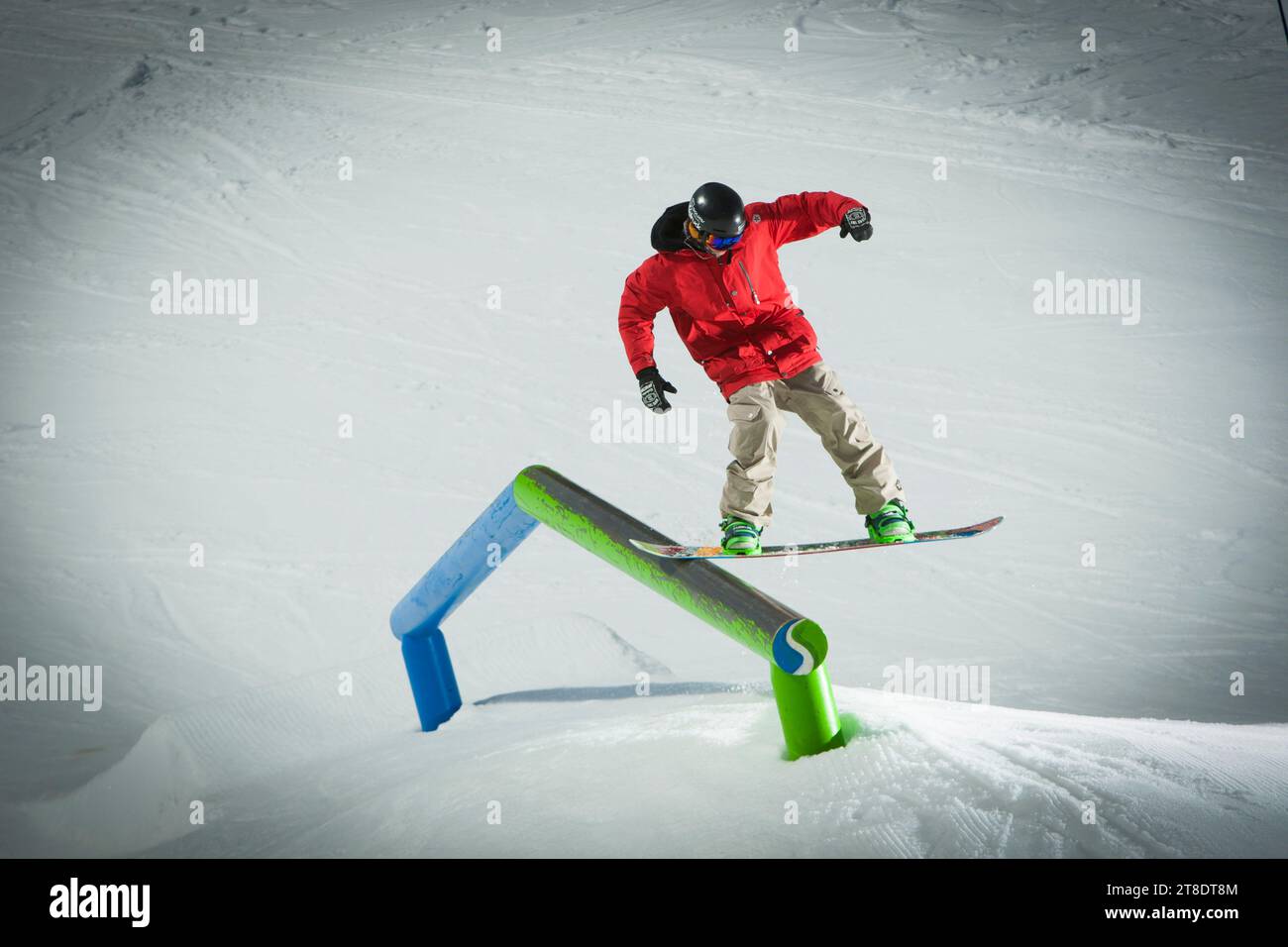 One male snowboarder jibbing a terrain park at a ski resort Stock Photo ...
