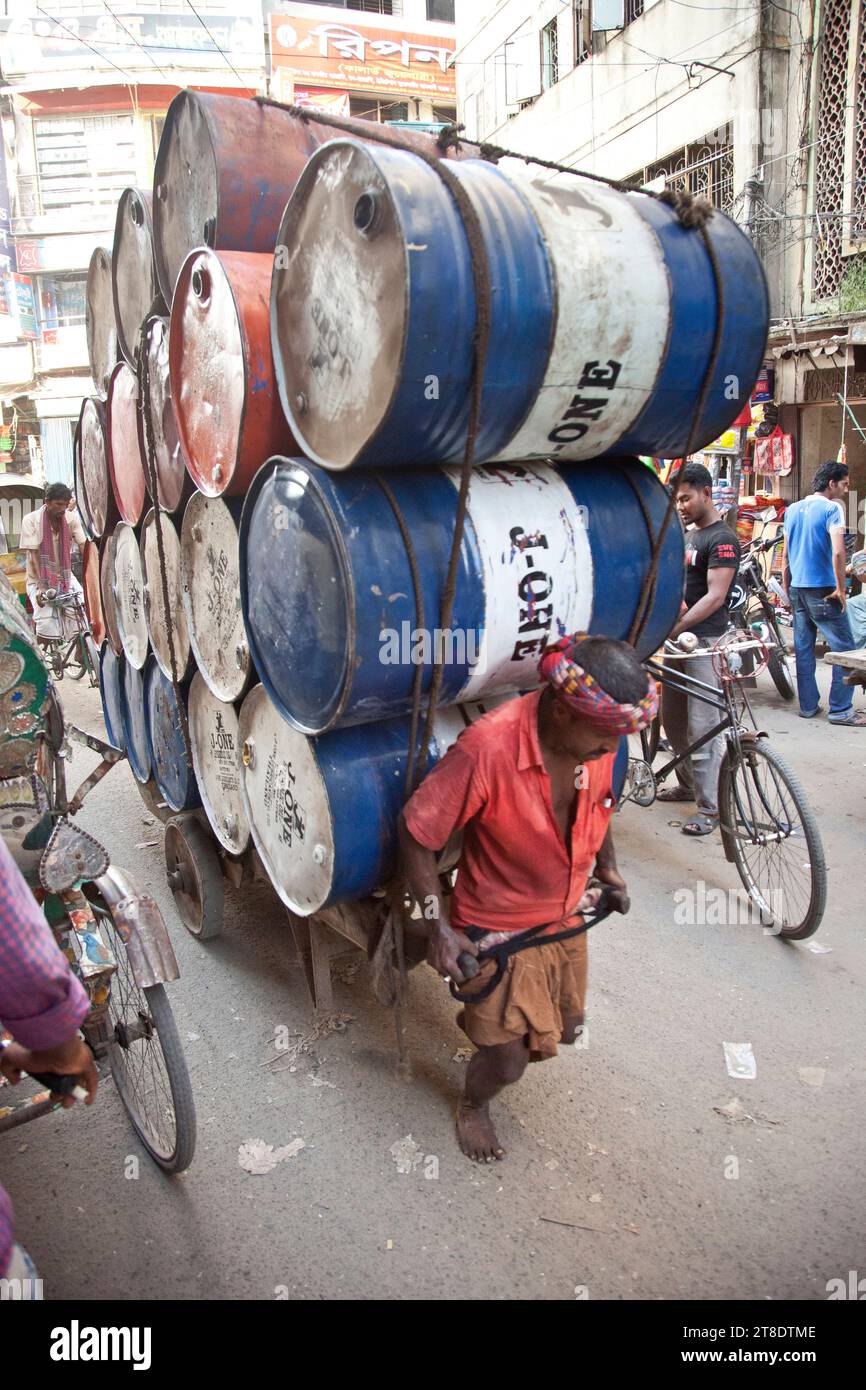 Man pulling oil drums in Bangladesh Stock Photo - Alamy