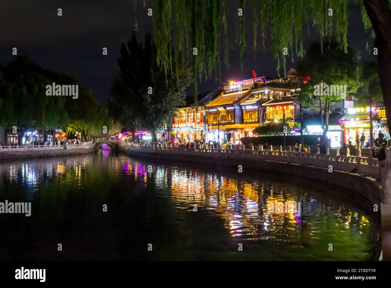 Night view of the restaurants and bridge at the Qianhai lake in Beijing ...