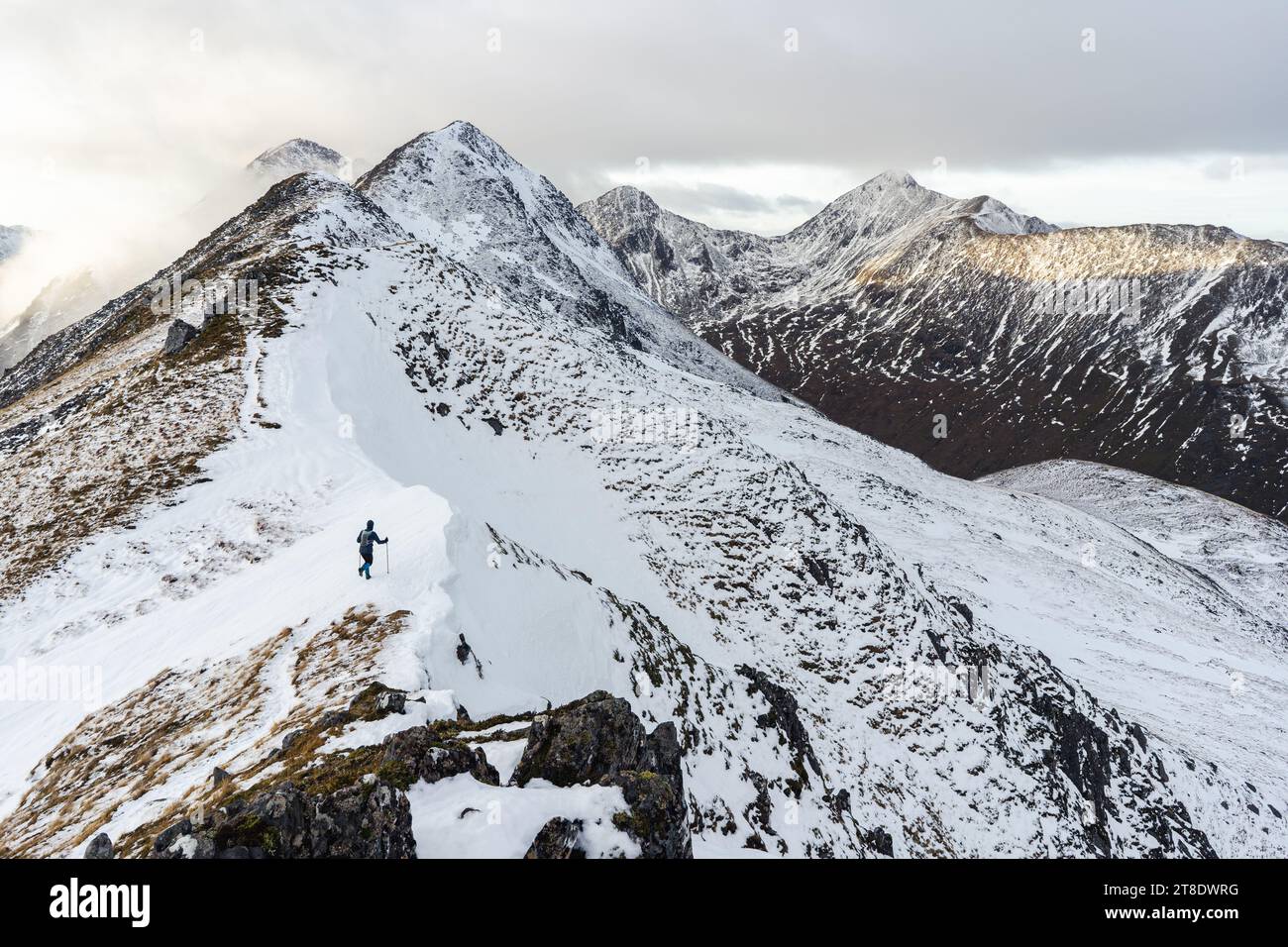 Solo female hiker on snowy mountain ridge Stock Photo - Alamy