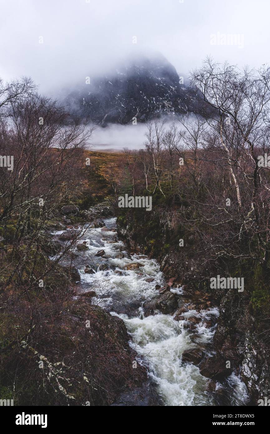 Cloud covered mountain and whitewater river Stock Photo - Alamy