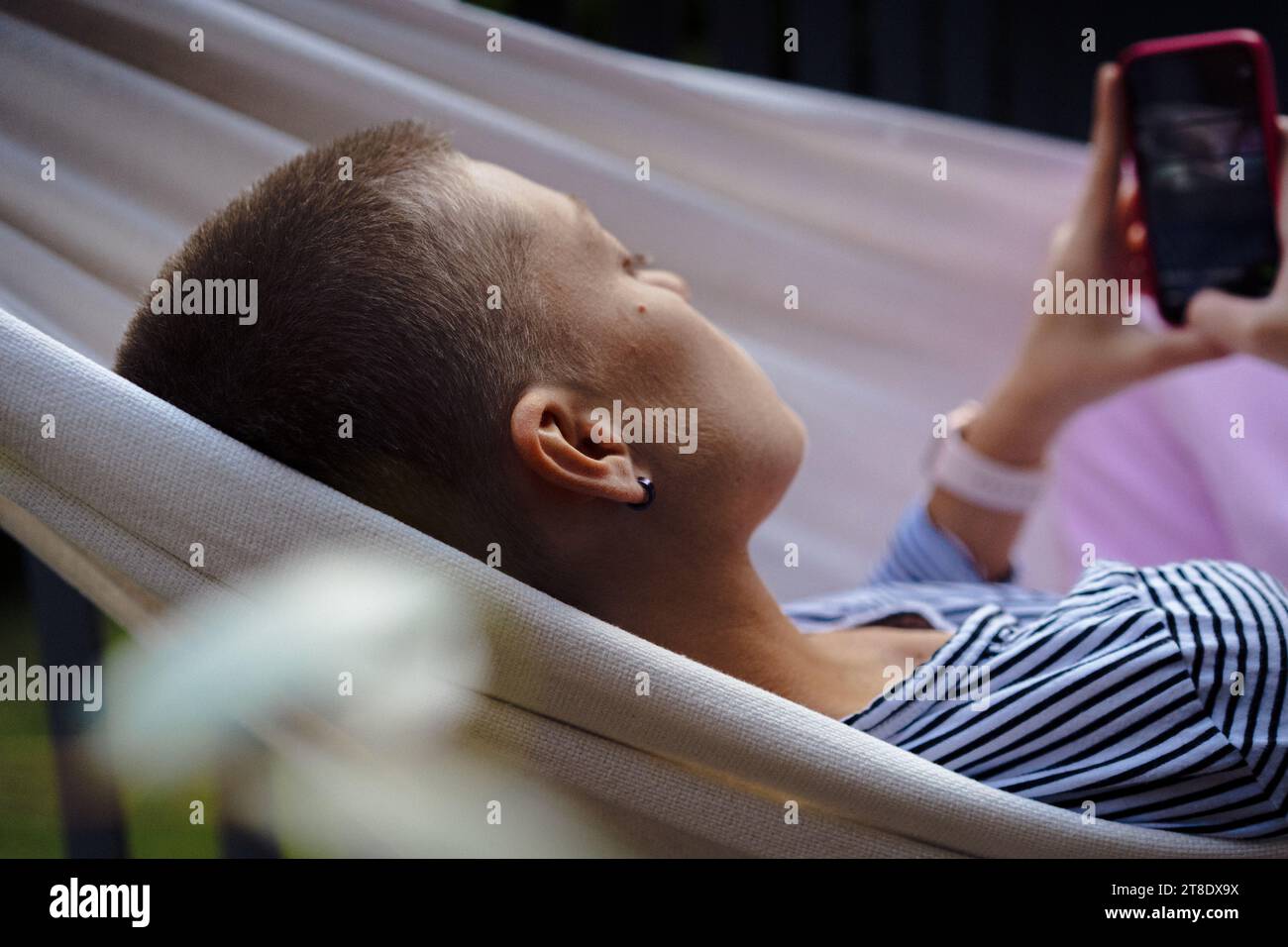 Young woman short haircut lies in a hammock, relaxation, portrait Stock ...