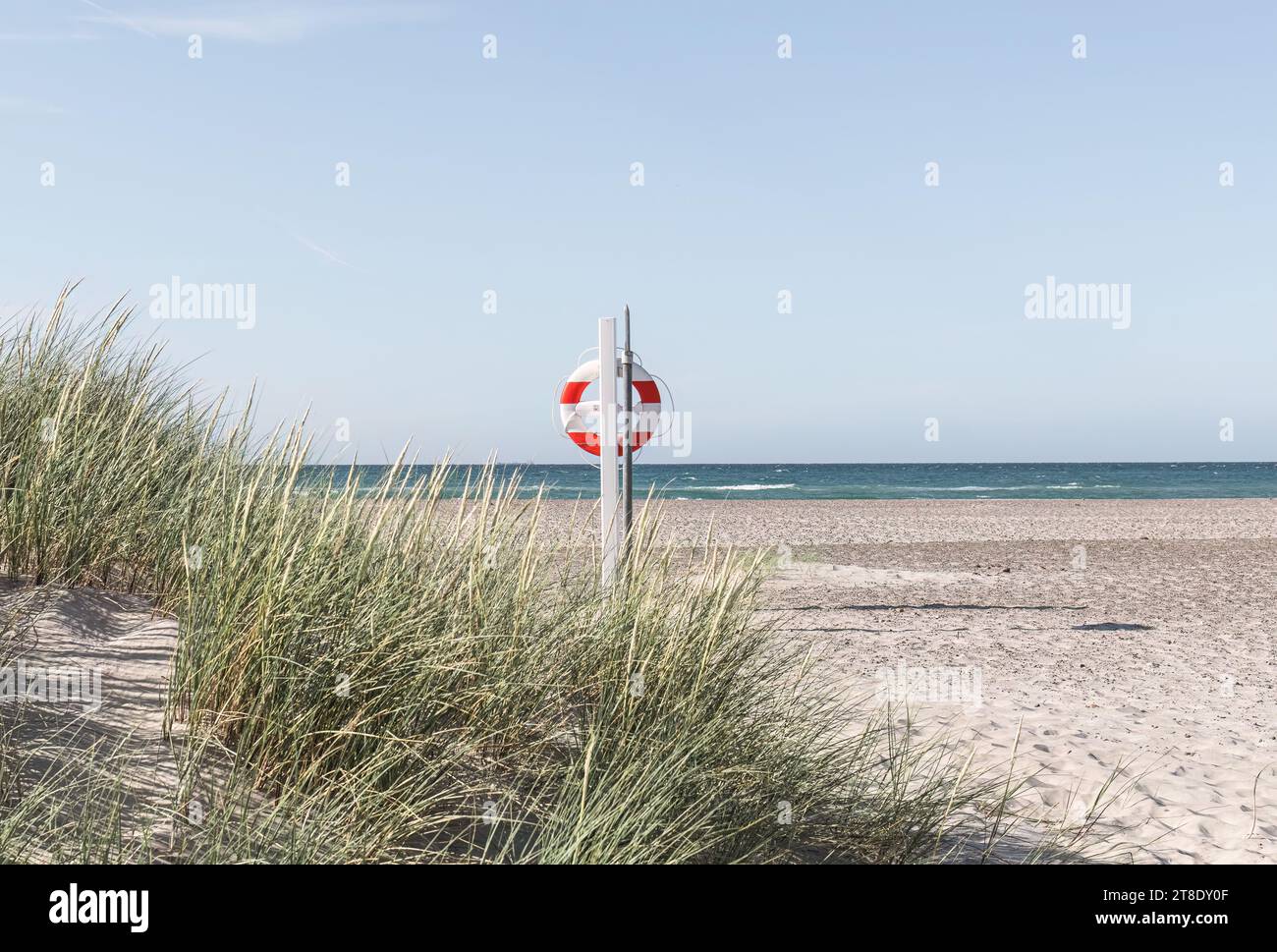Life preserver on sandy beach on the shore of the North Sea in Denmark ...