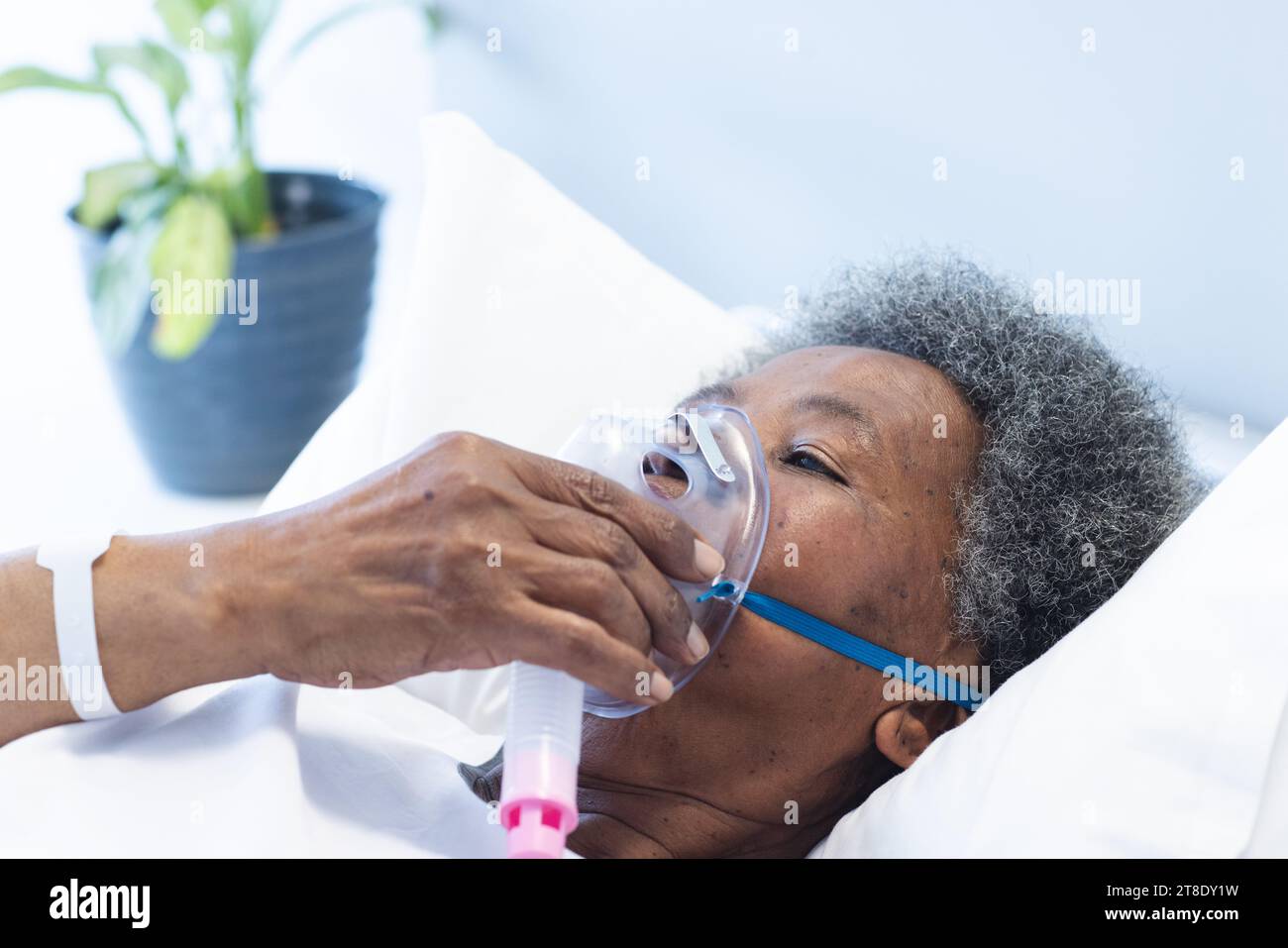 African american female senior patient wearing oxygen mask in hospital ...