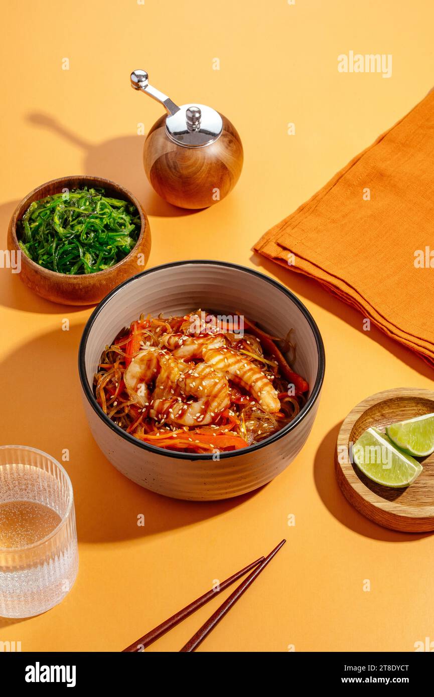 asian noodles with chicken and vegetables. menu. orange background ...