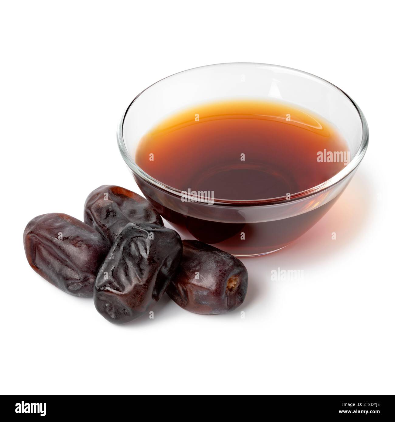 Glass bowl with date vinegar and dried dates in front isolated on white ...