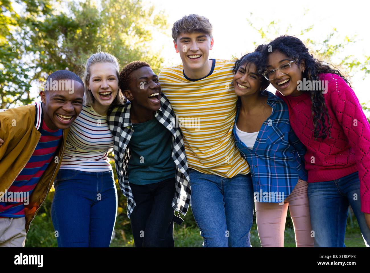 Portrait happy diverse friends embracing hi-res stock photography and ...