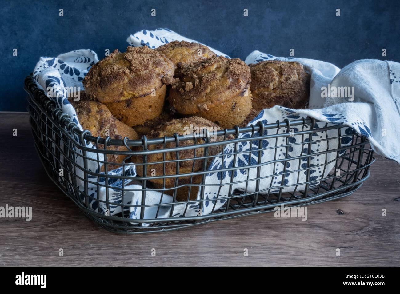 Pumpkin muffins in towel-lined basket on wooden counter Stock Photo - Alamy