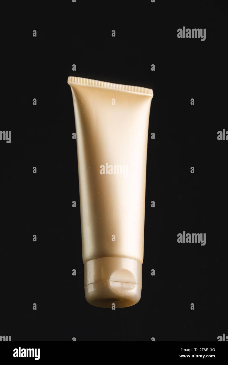 Vertical image of beauty product tube with copy space on black ...