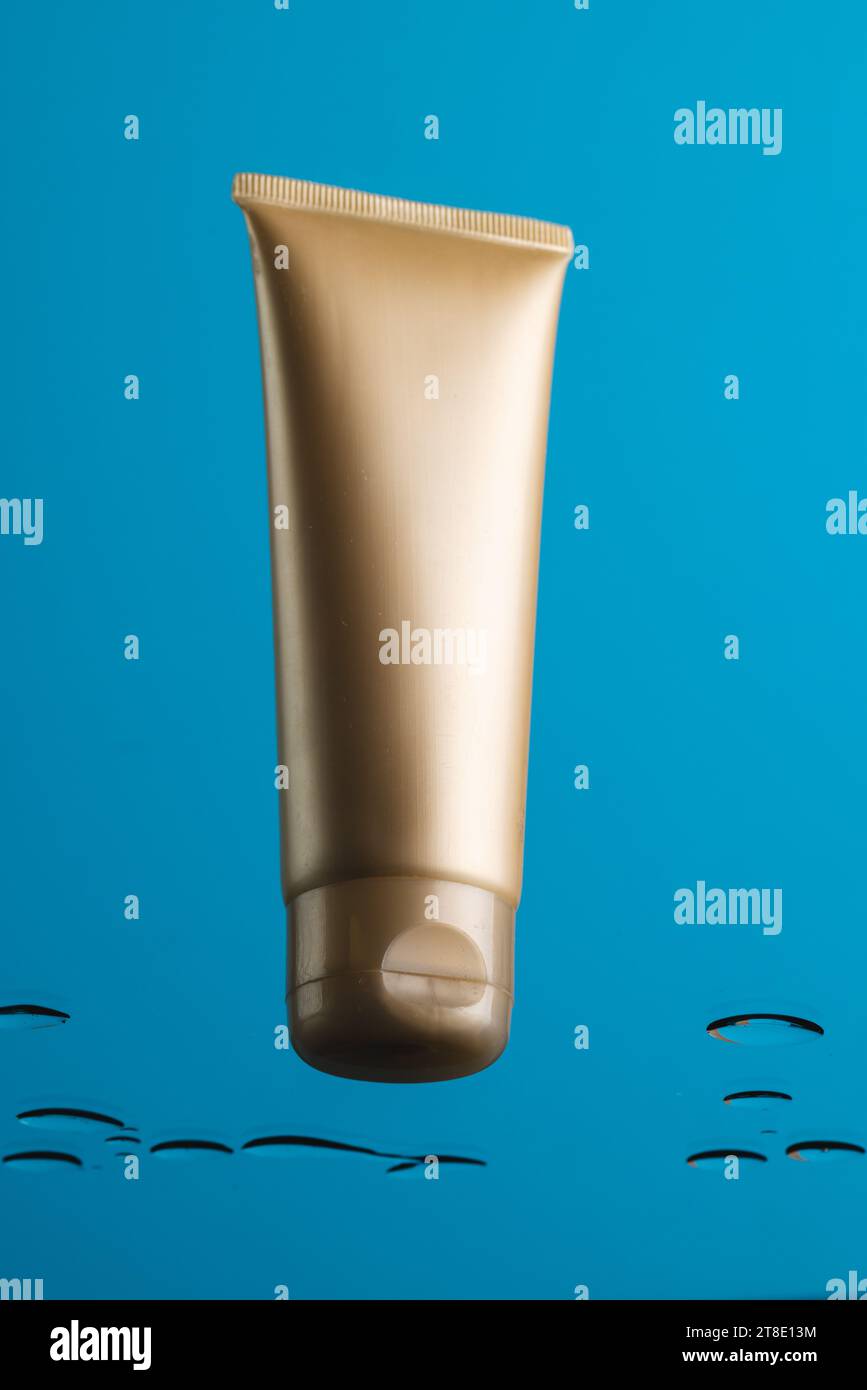Vertical image of beauty product tube with water drops, copy space on ...
