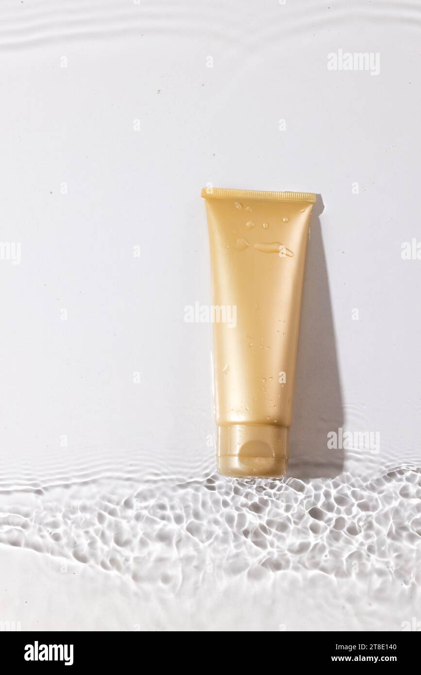 Vertical image of beauty product tube in water with copy space ...