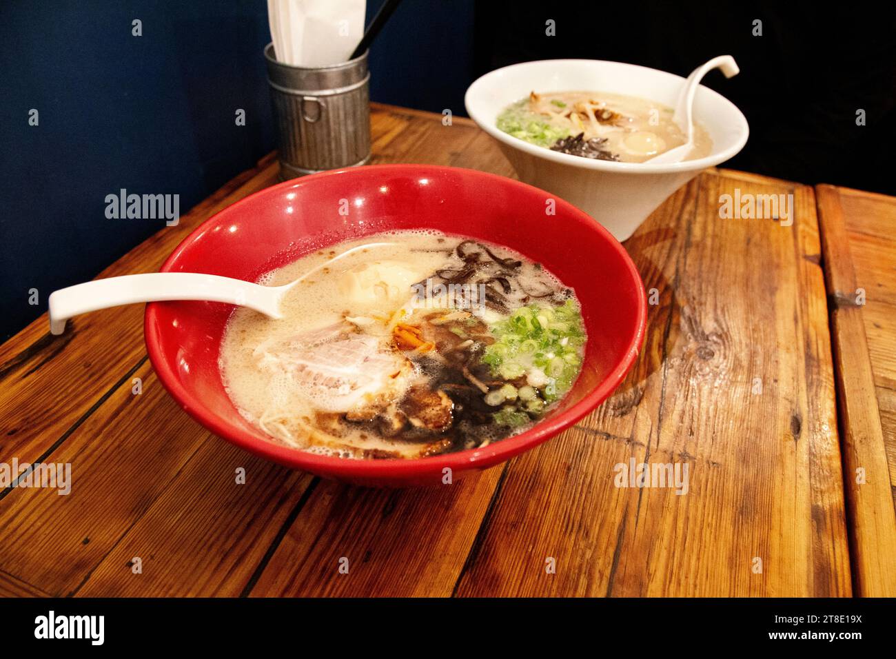 Bowl of pork ramen topped with chashu, egg, muchrooms and spring onion ...