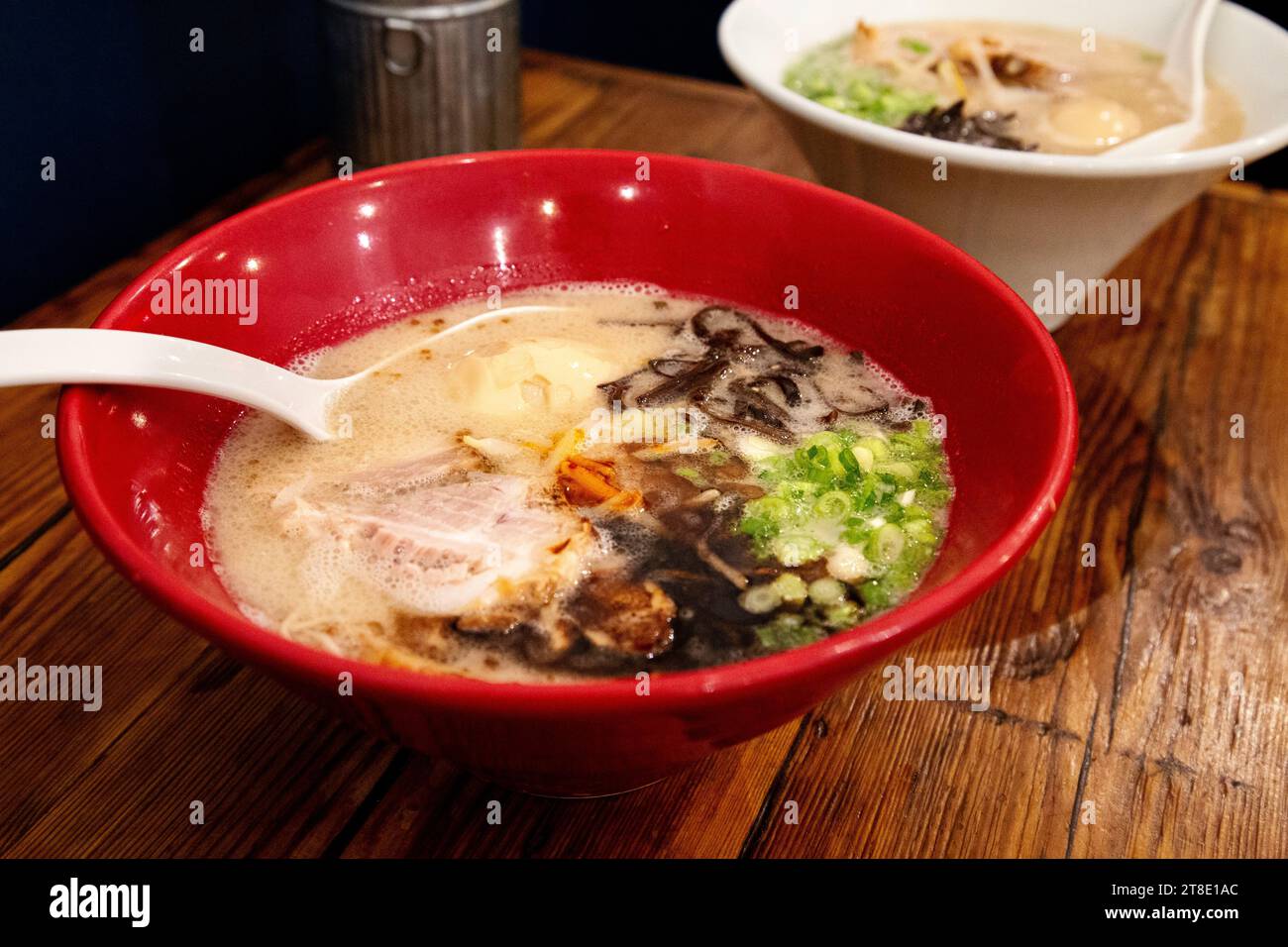 Bowl of pork ramen topped with chashu, egg, muchrooms and spring onion ...