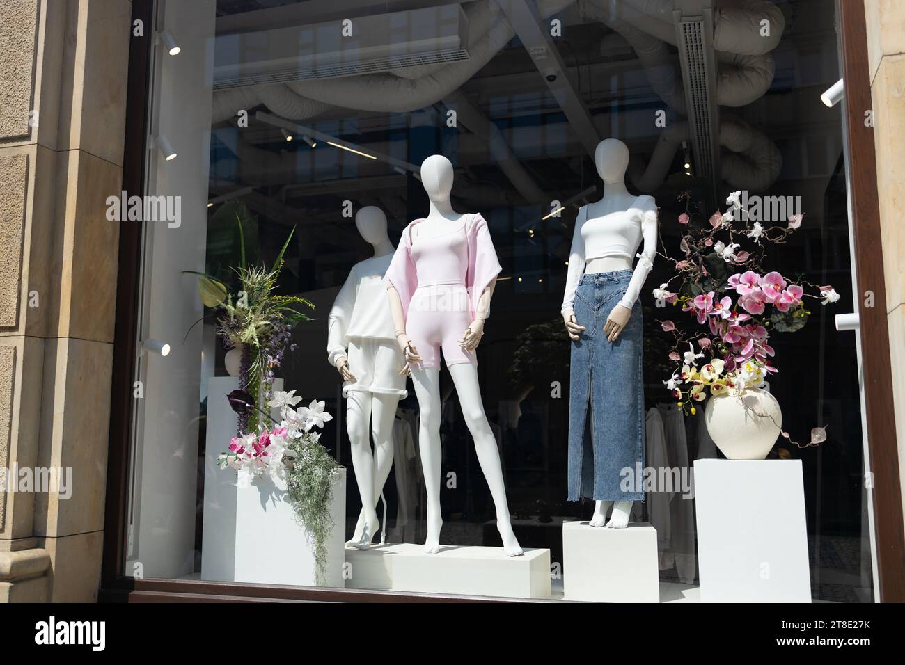 Female mannequins in shop window. Three women dummies show fashionable ...
