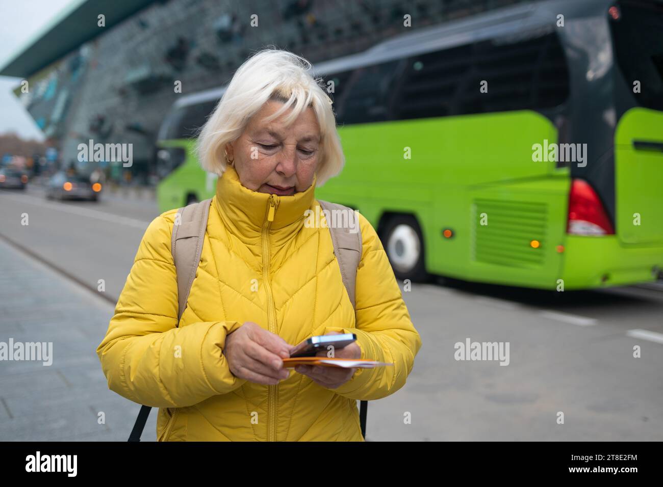 Tourist is waiting a taxi. Senior woman stand outside airport and wait ...