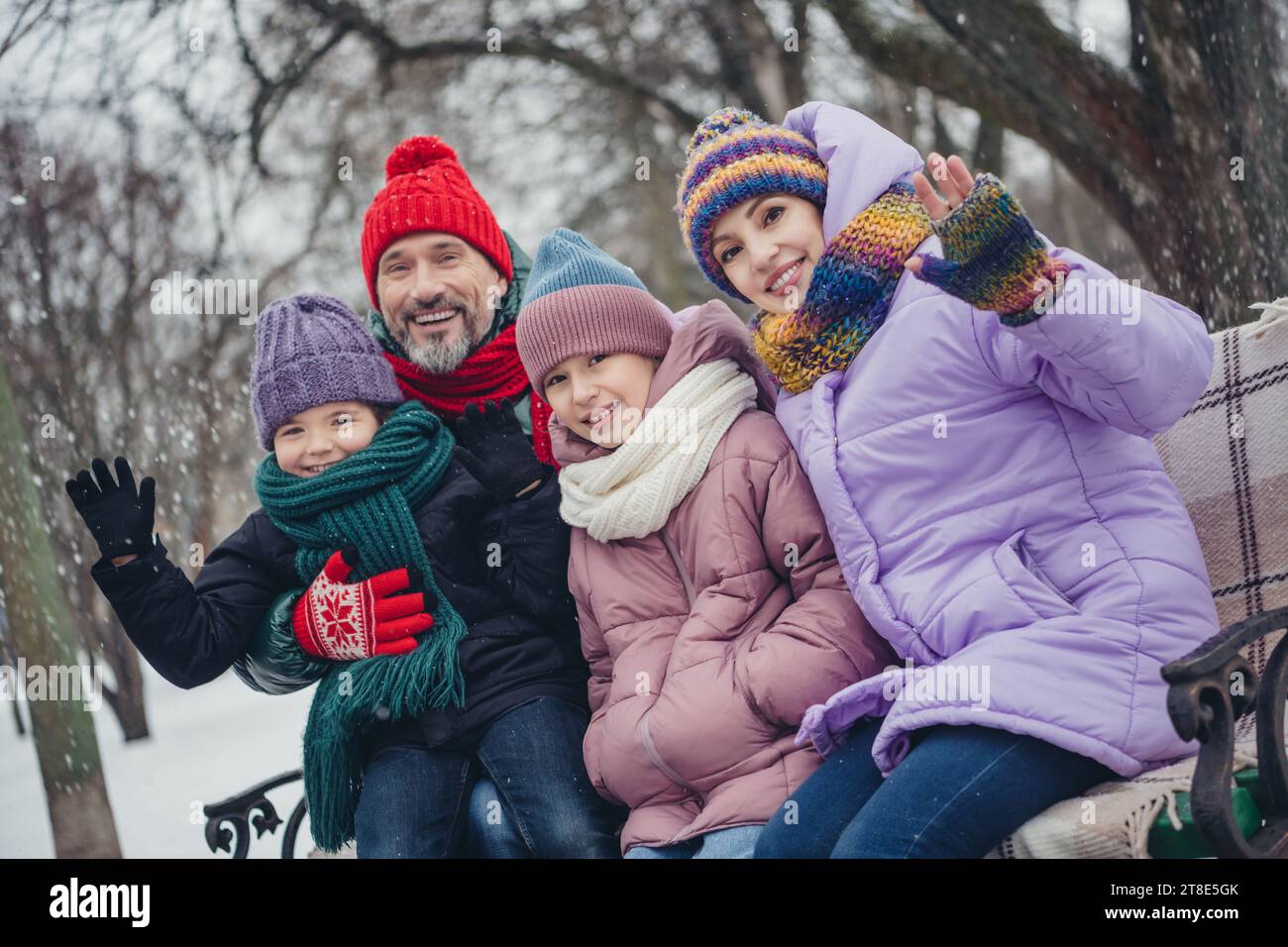 Portrait of full friendly family sitting bench chilling arm waving hi ...