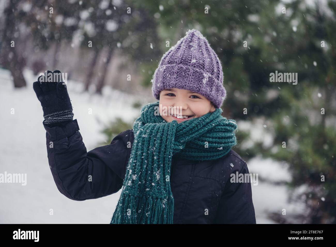 Photo of friendly funny small kid wear windbreaker hat waving arm hi ...