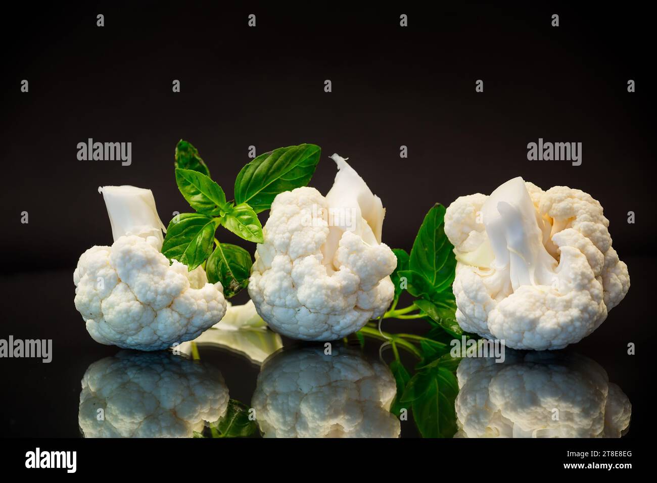 slices of raw small raw cauliflower isolated on black background Stock ...