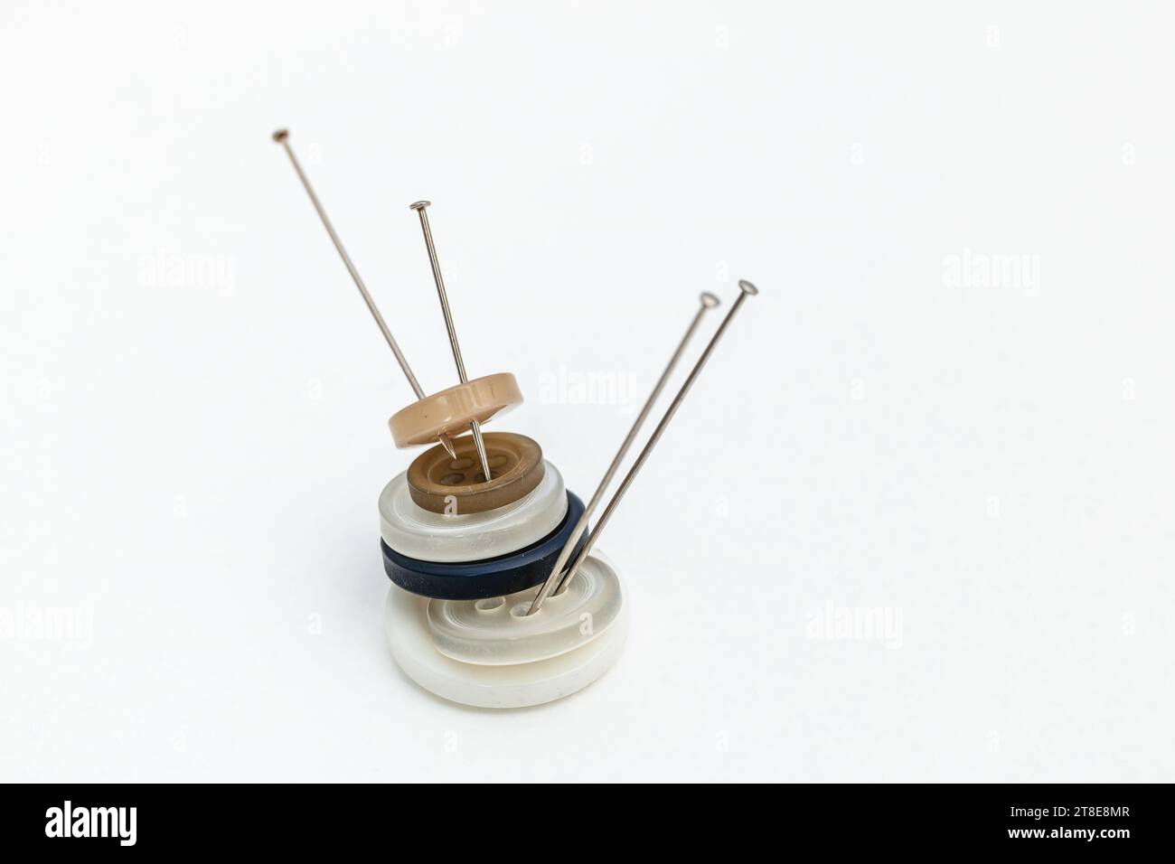 Horizontal photo, buttons stacked with pins, on white background, copy ...