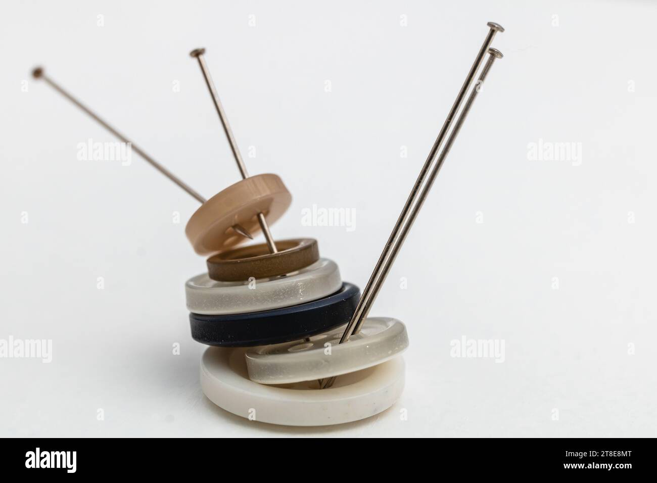 Horizontal photo, buttons stacked with pins, on white background, copy ...