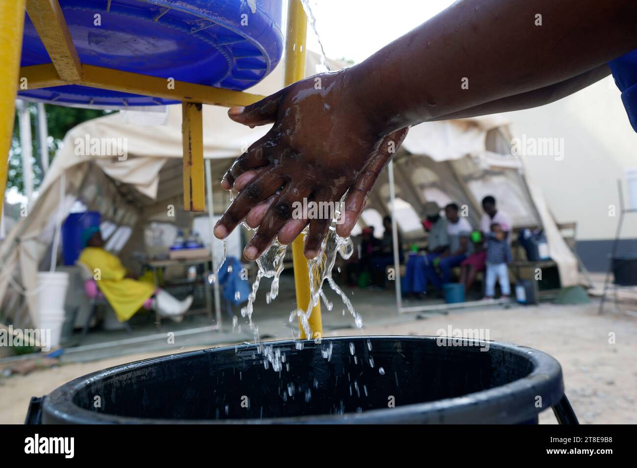 A woman washes her hands before entering a tent with cholera patients ...