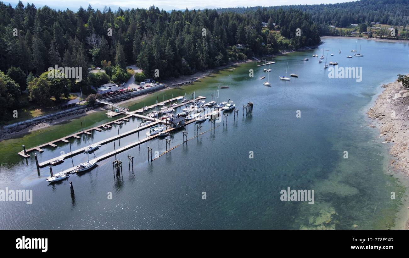 Sailing boat, motorboats, dock and little island. Little harbour from ...