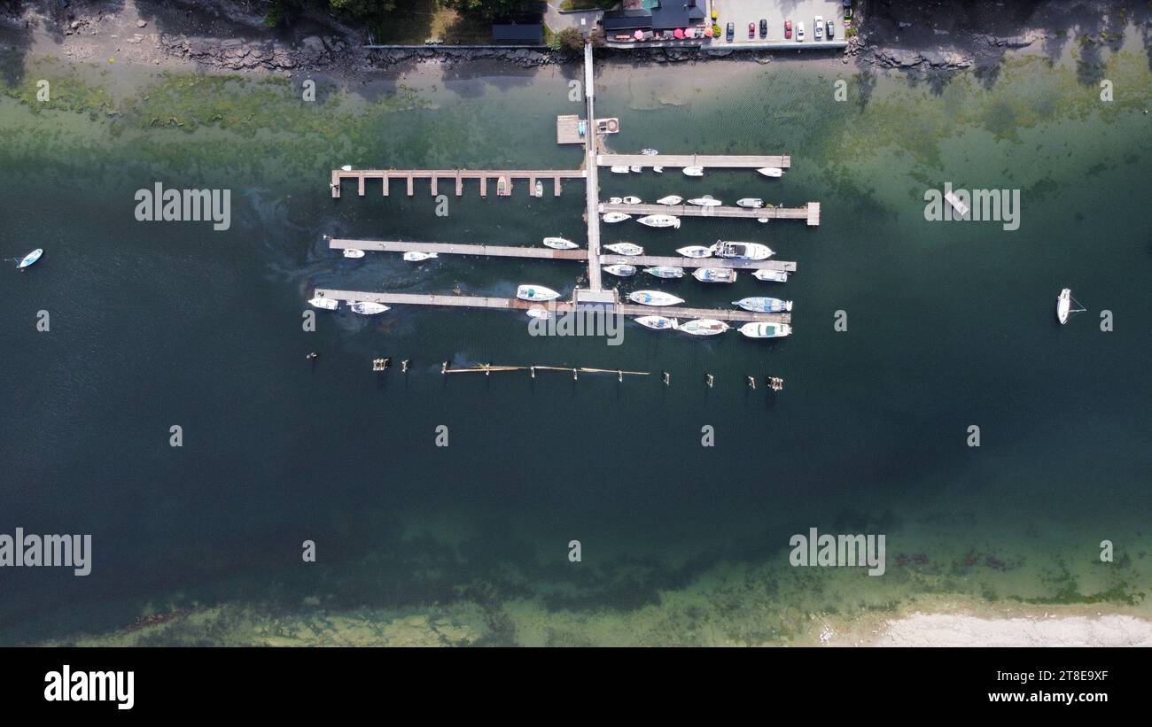 Sailing boat, motorboats, dock and little island. Little harbour from ...