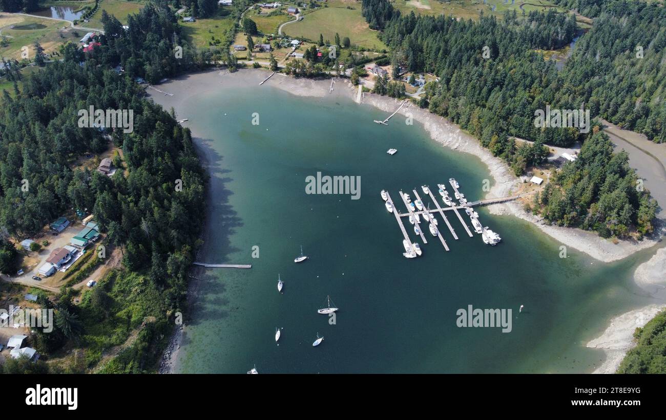 Sailing boat, motorboats, dock and little island. Little harbour from ...