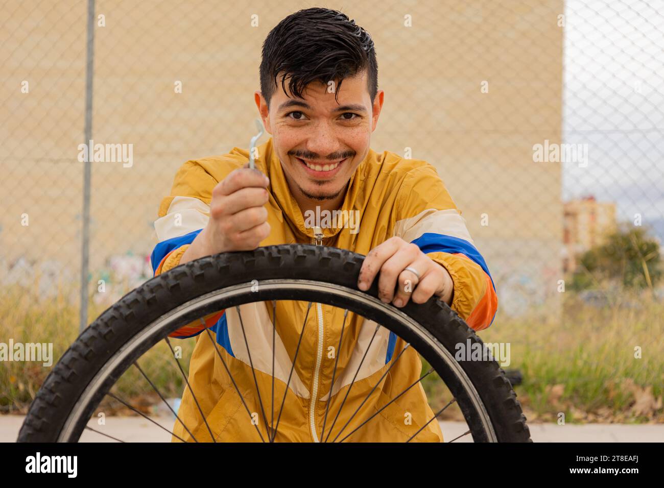 young sportsman laughs when he sees that the tool to remove his tire is ...