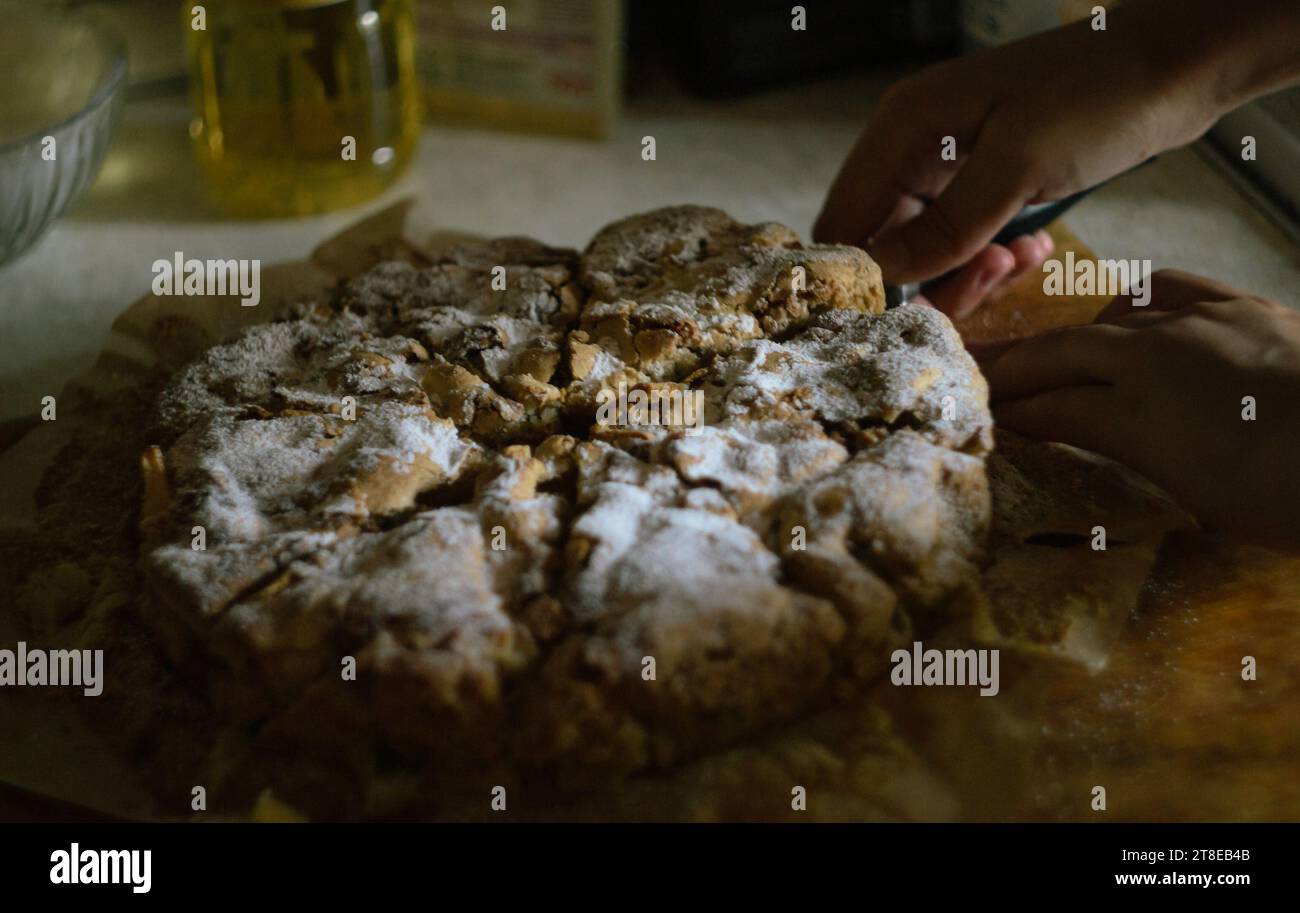 Women's hands want to take a cut off piece of ready-made charlotte ...