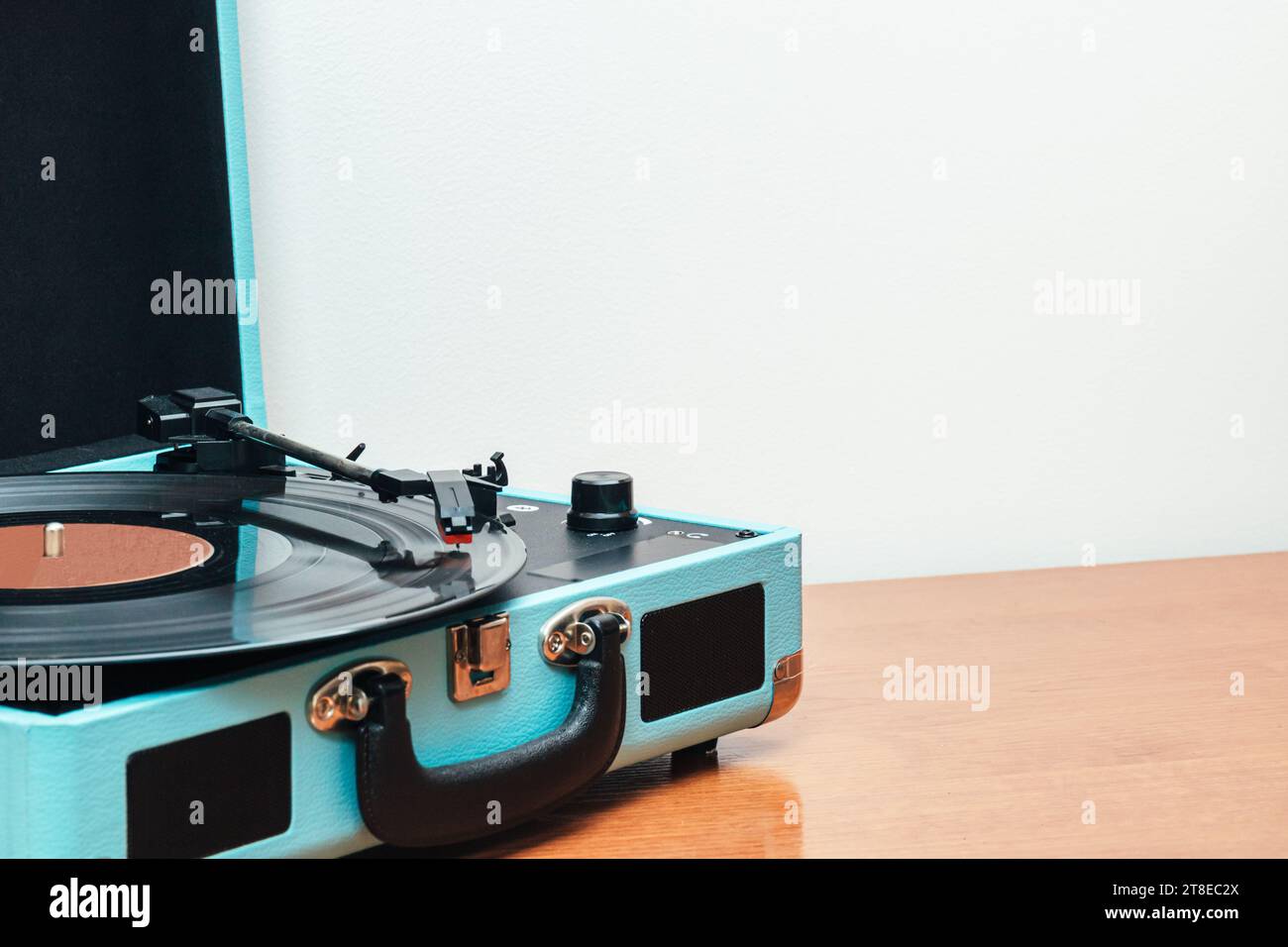 Horizontal photo of a record player in the shape of a blue suitcase, on ...
