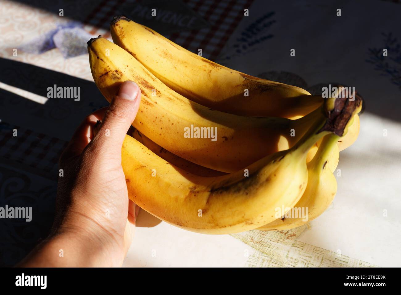 Bunch of bananas in the arm Stock Photo - Alamy