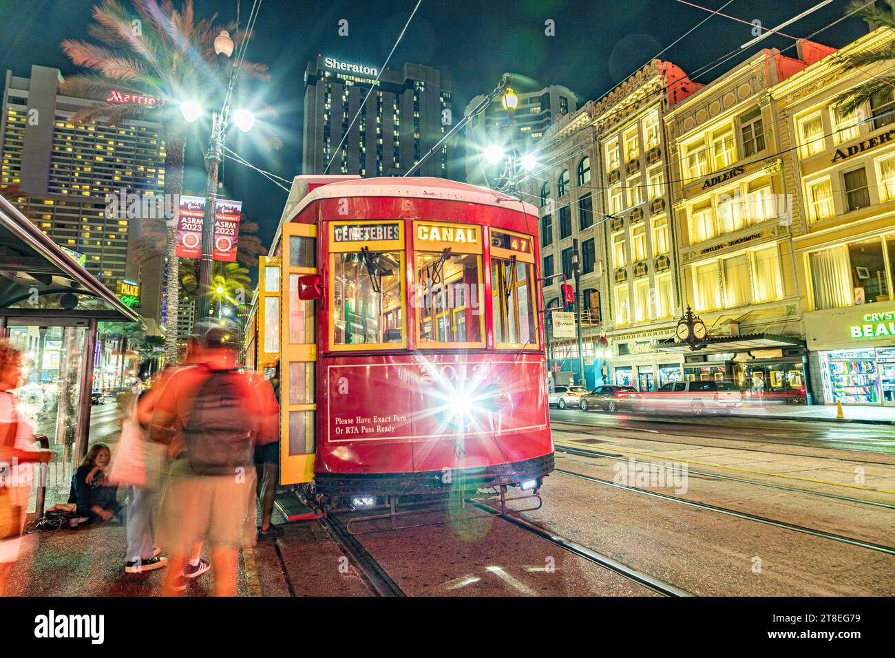 New Orleans, USA - October 24, 2023: people enter the red street car at ...