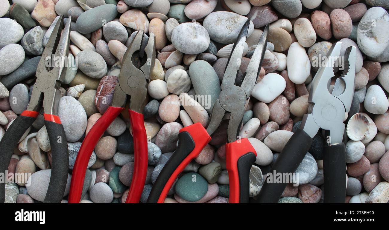 Top parts of variety types of pliers lined up in size comparison on a ...