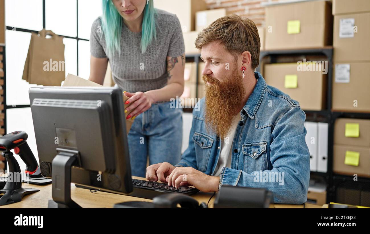 Man and woman ecommerce business workers using computer with serious ...