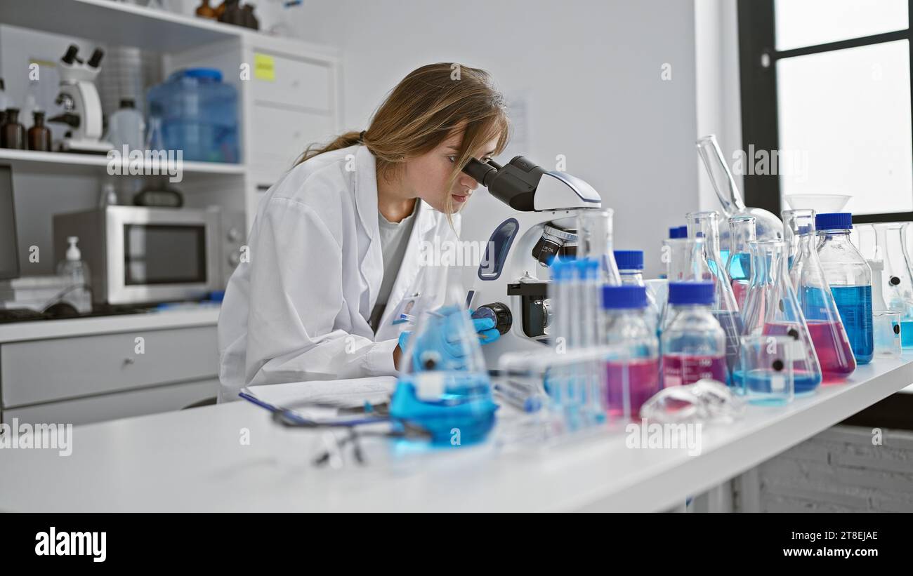 In the heart of science, young attractive blonde woman scientist ...