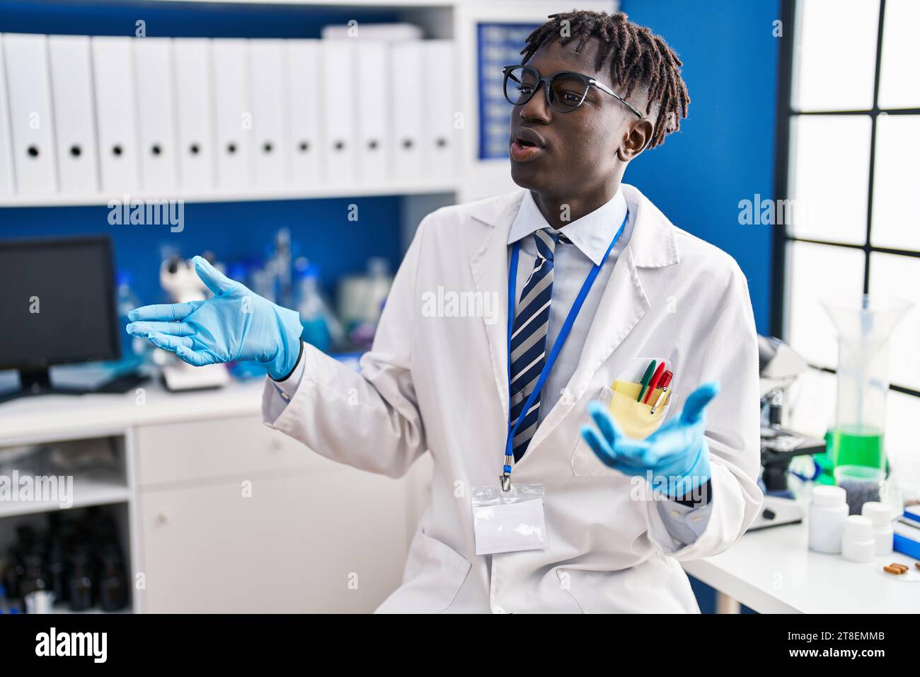 African american man scientist speaking at laboratory Stock Photo - Alamy