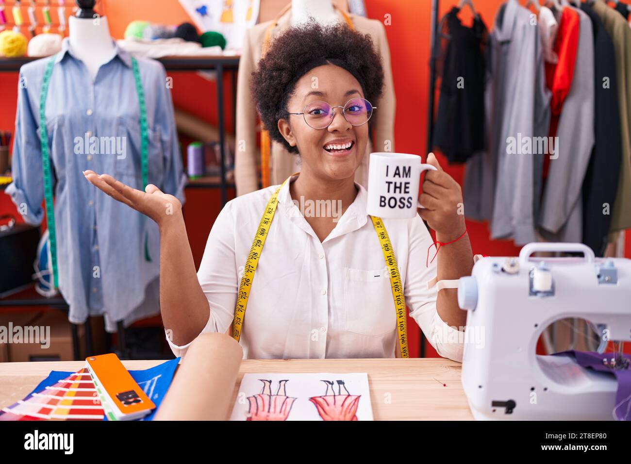 Beautiful african woman with curly hair dressmaker designer drinking ...