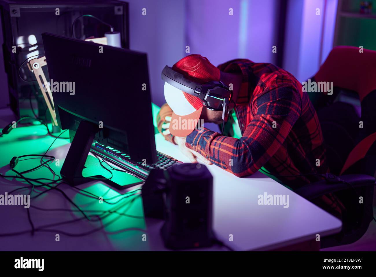 Young caucasian man streamer stressed using computer at gaming room ...