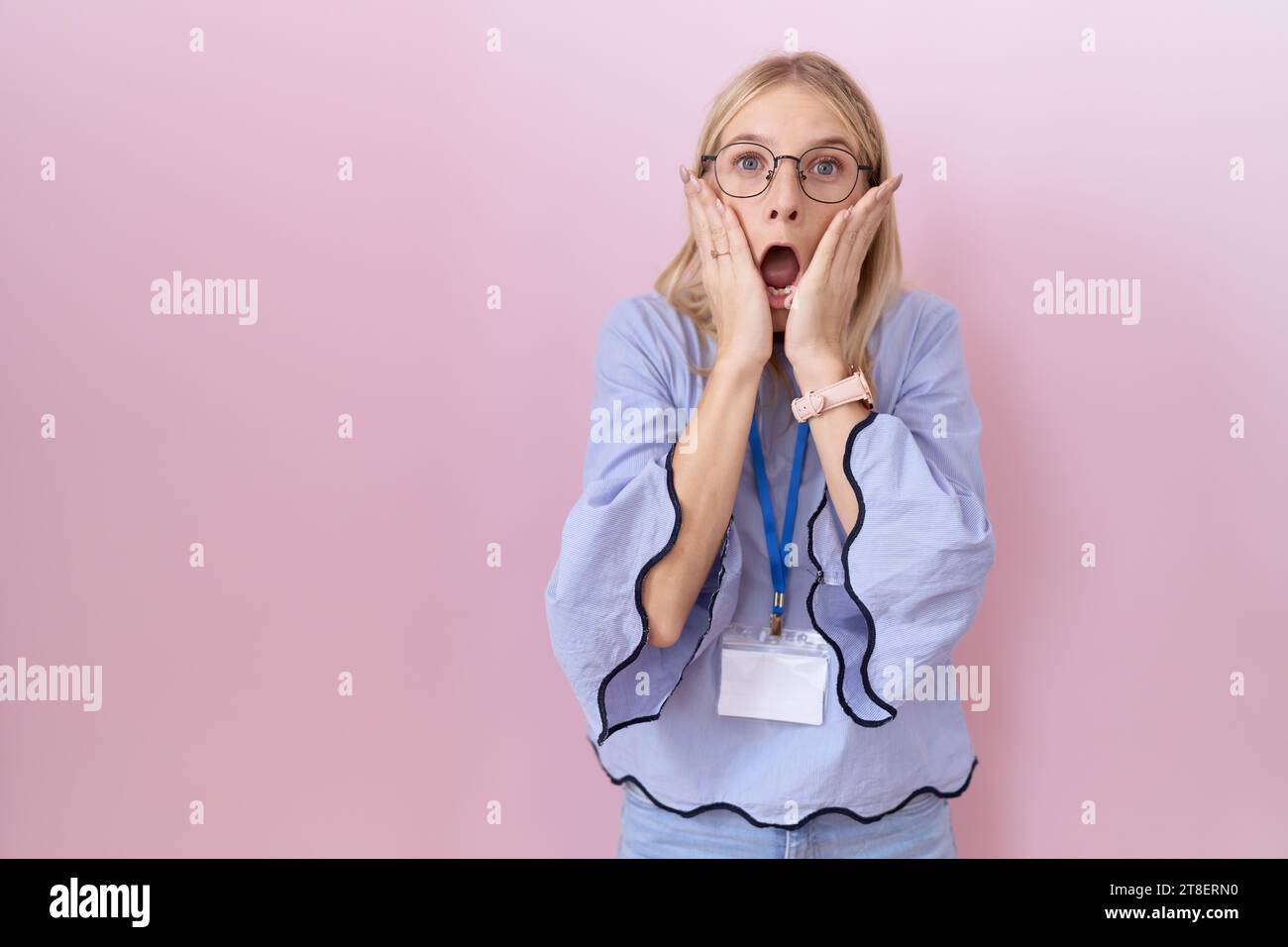 Young caucasian business woman wearing id card afraid and shocked ...