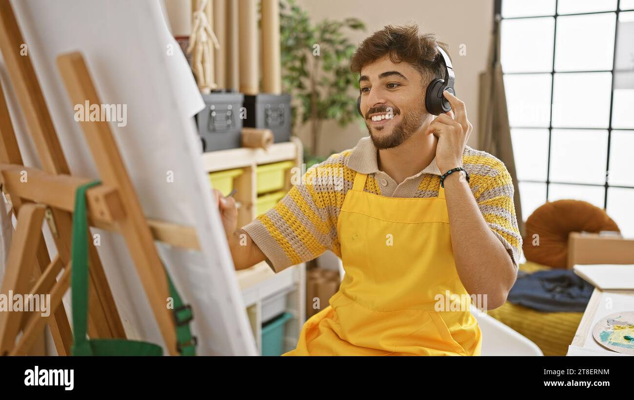 Endearing scene of a bearded young arab man, confident artist, eagerly ...