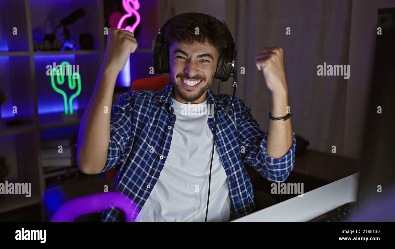 Handsome young arab man, a confident gamer, streams night win at his ...