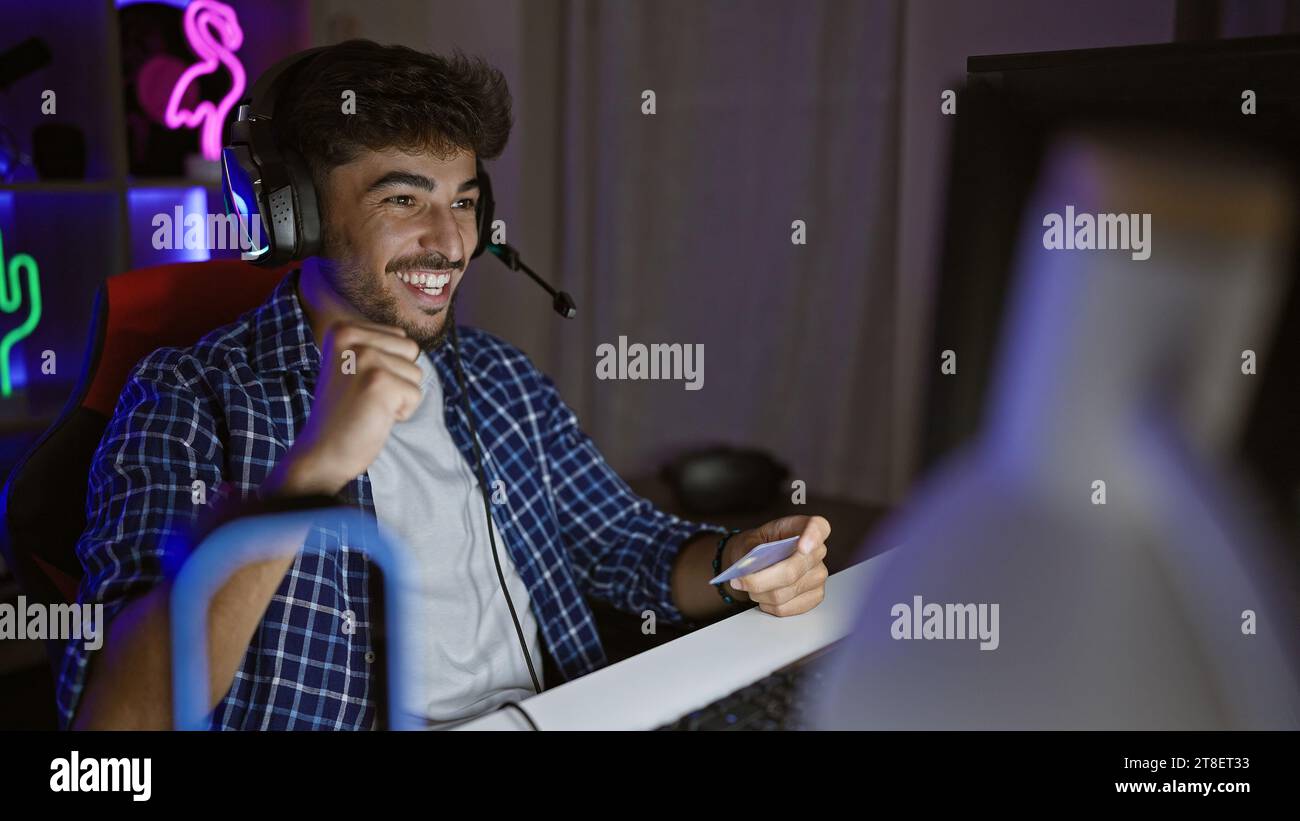Handsome young arab man, a confident gamer, streams night win at his ...