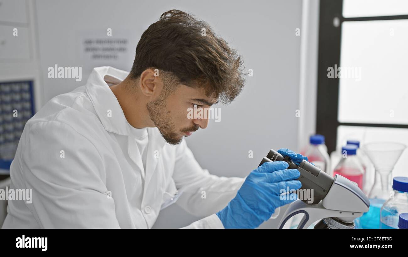 Young arab man scientist using microscope at laboratory Stock Photo - Alamy