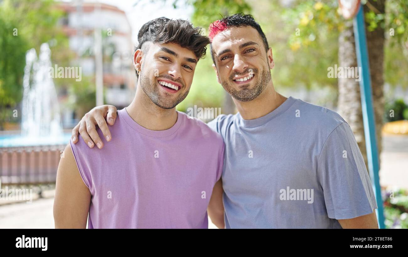 Two men couple smiling confident hugging each other at park Stock Photo ...