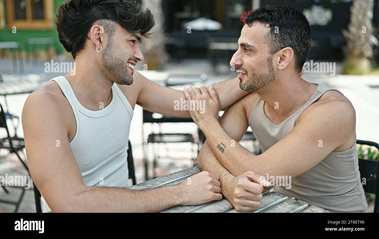 Two gay men sitting table hi-res stock photography and images - Alamy