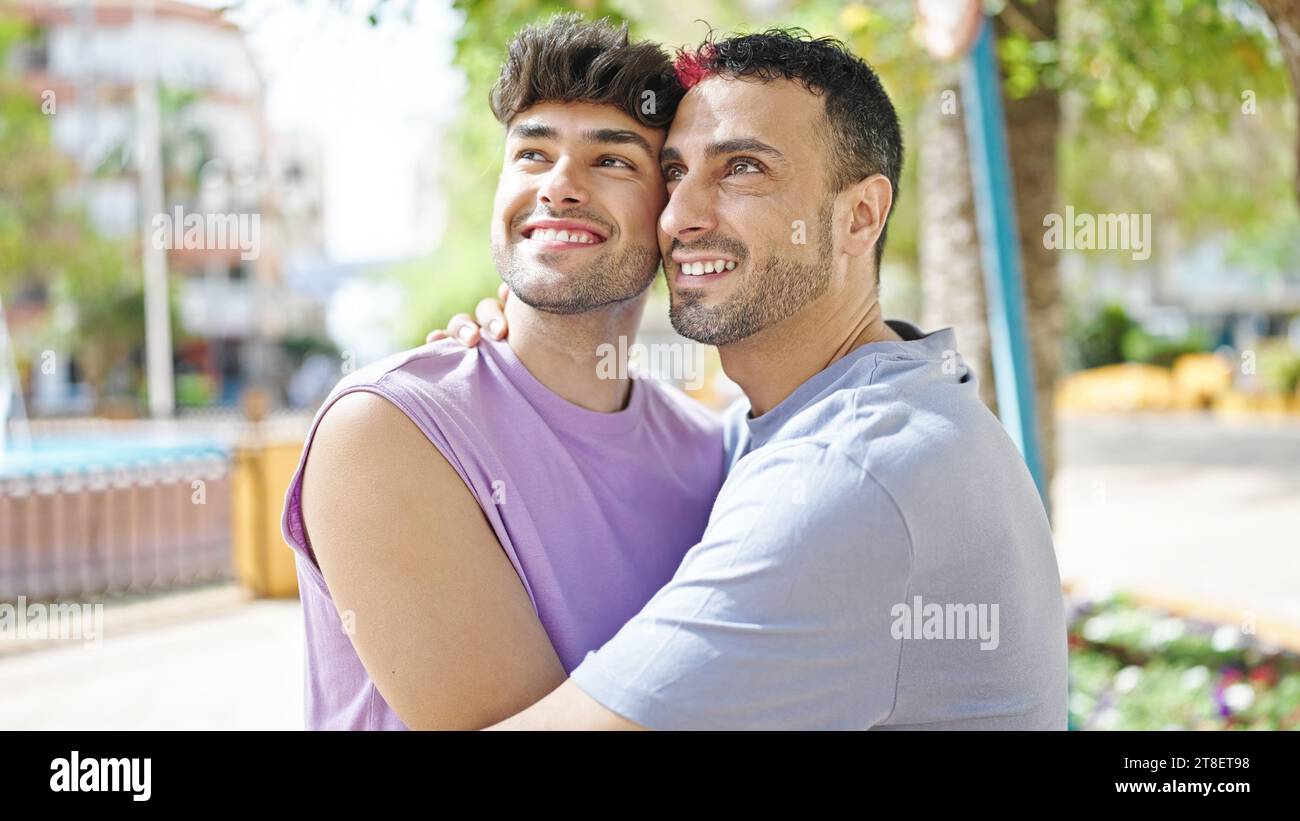 Two men couple smiling confident hugging each other at park Stock Photo ...