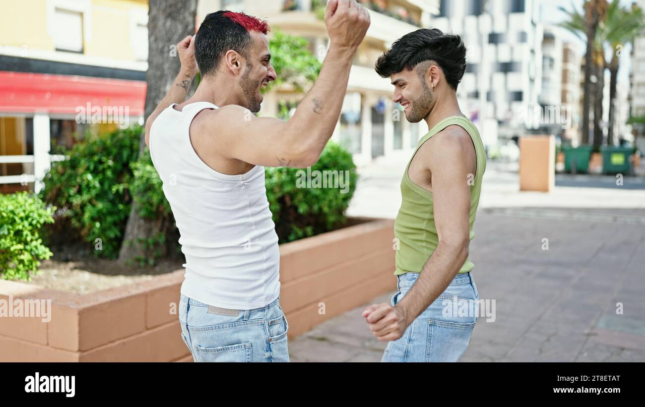 Two men couple smiling confident dancing at park Stock Photo - Alamy