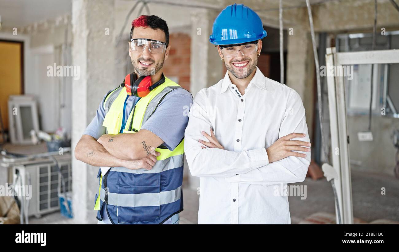 Two men builder and architect smiling confident standing with arms ...